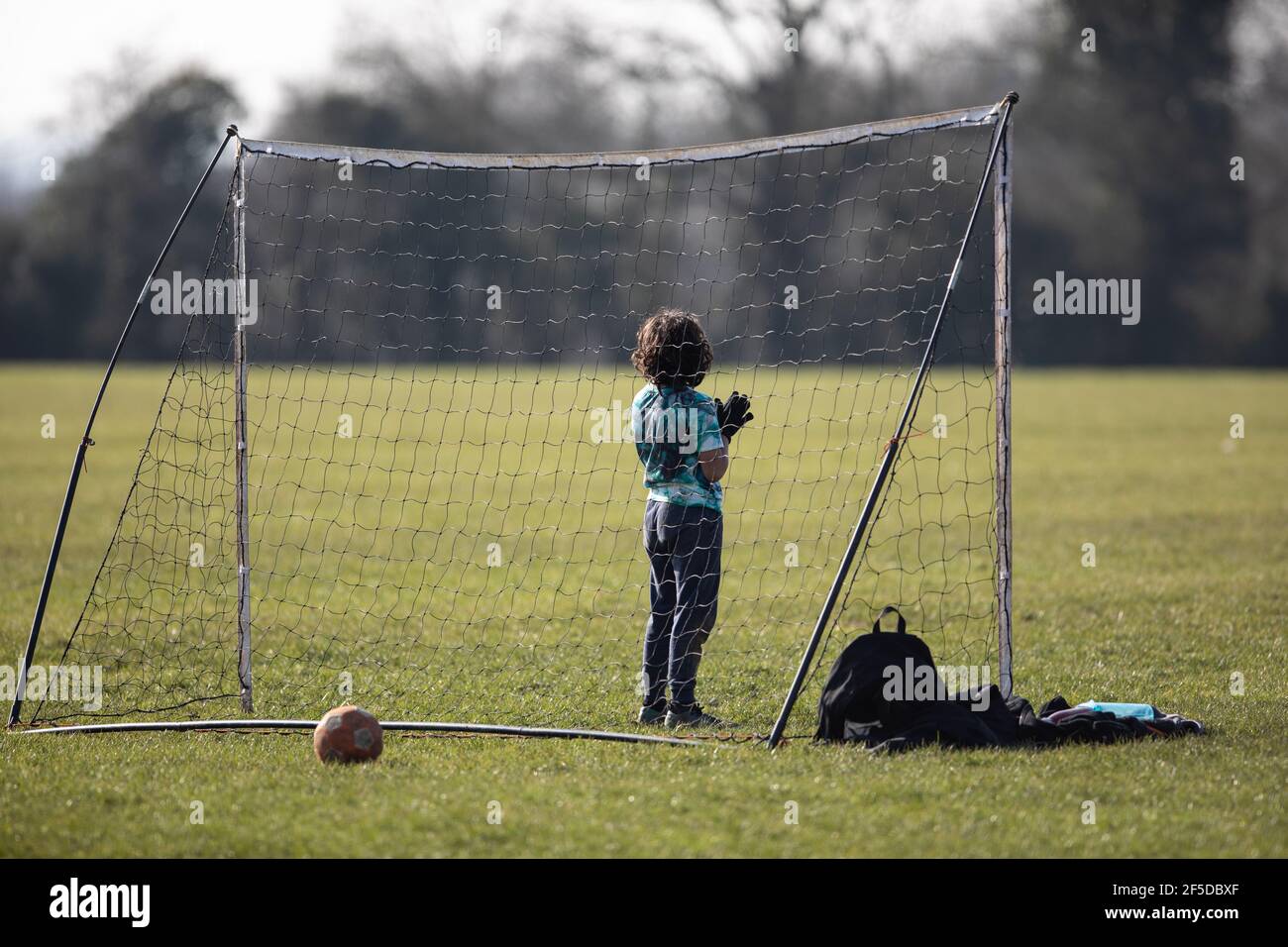 Diverse kids playing soccer in park hi-res stock photography and images ...