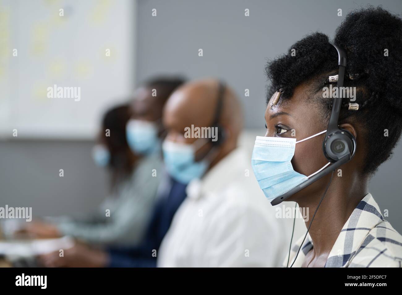 Customer Service And Contact Center In Covid Mask Stock Photo - Alamy
