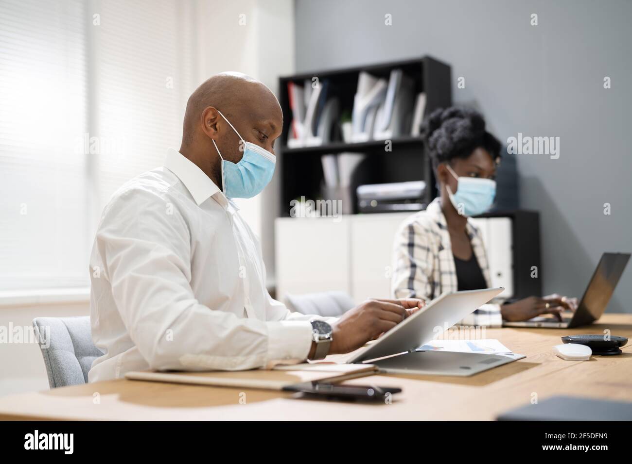 Team Employees Wearing Covid Face Mask At Meeting Stock Photo - Alamy