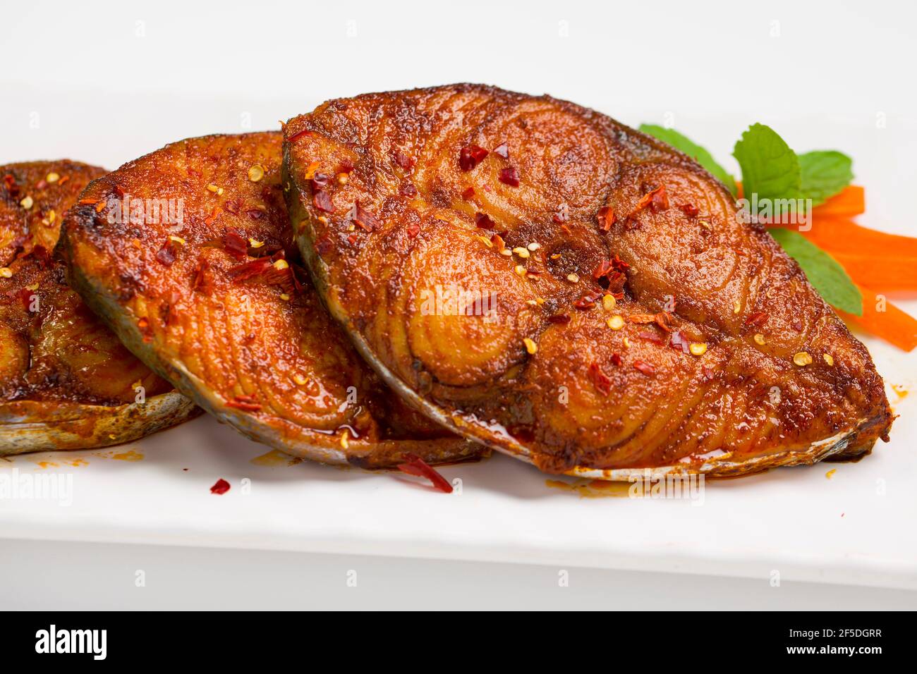Seer fish fry arranged beautifully and garnished with onion, lemon and ...