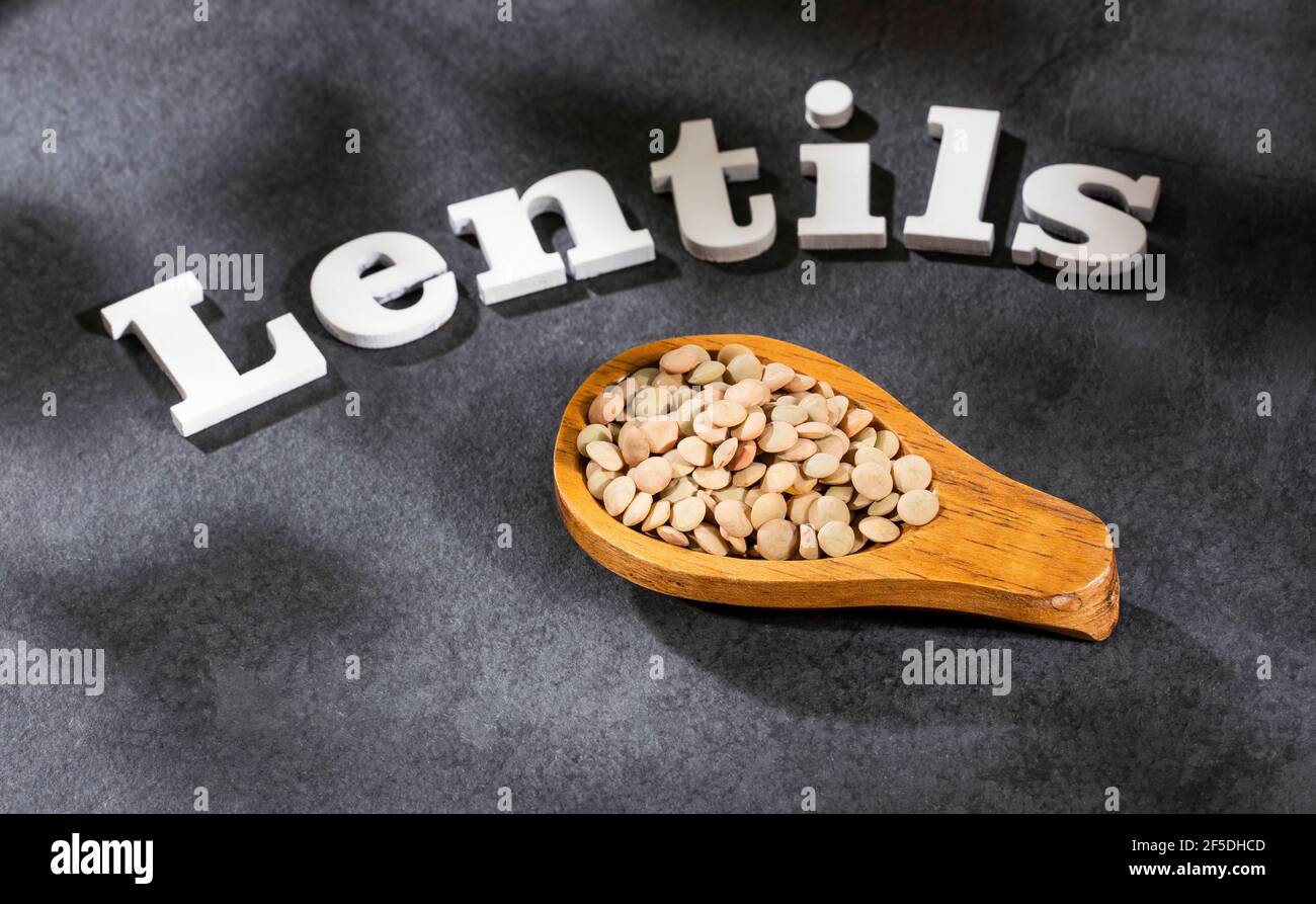Lens culinaris - Dried and uncooked lentils in the wooden spoon Stock ...