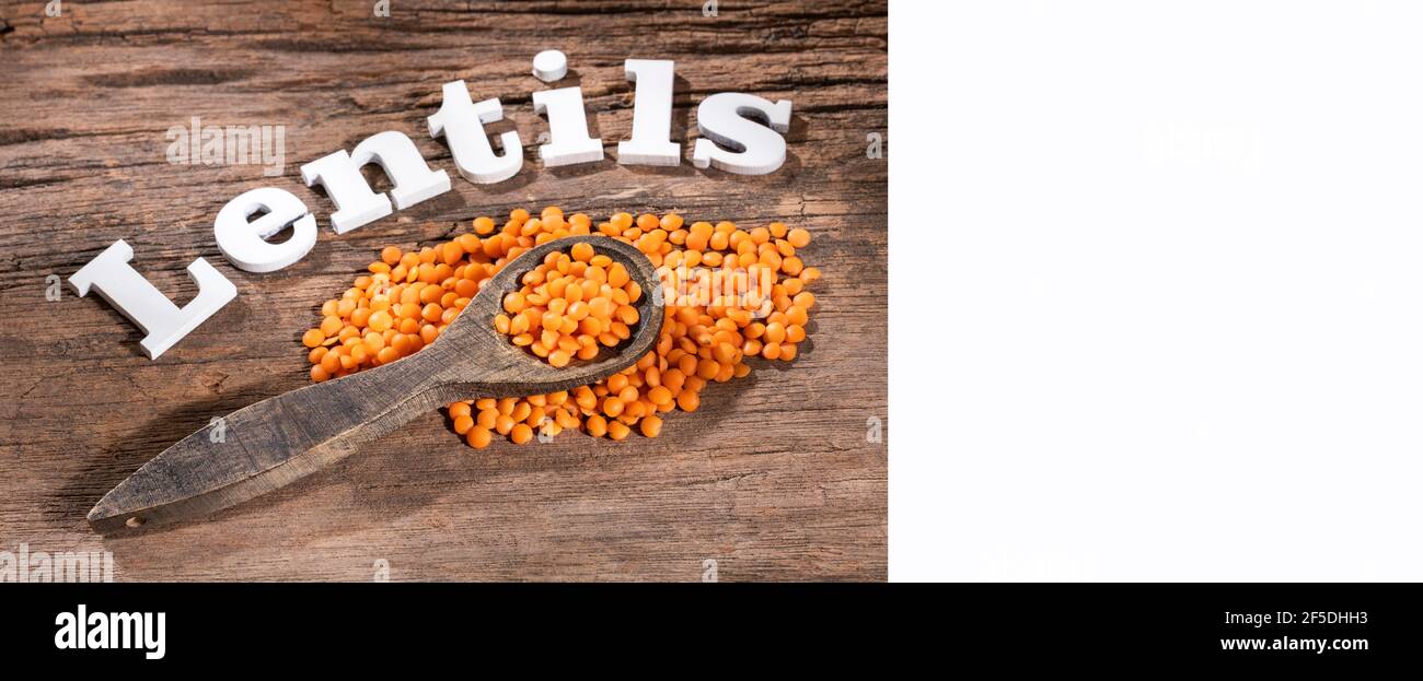 Heap of raw red lentils in wooden spoon - Lens culinaris Stock Photo ...
