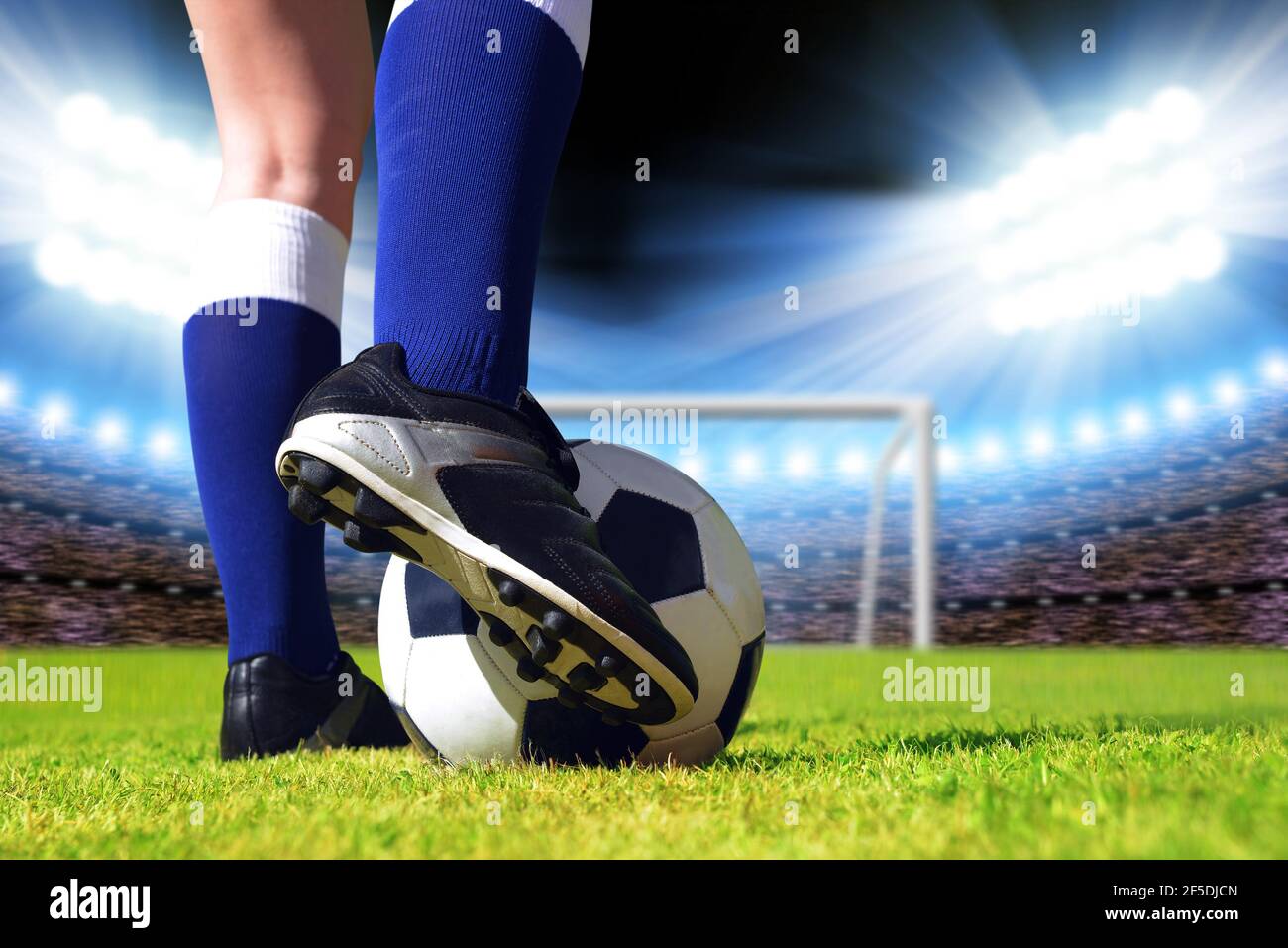 Soccer ball and foot of football player Stock Photo - Alamy