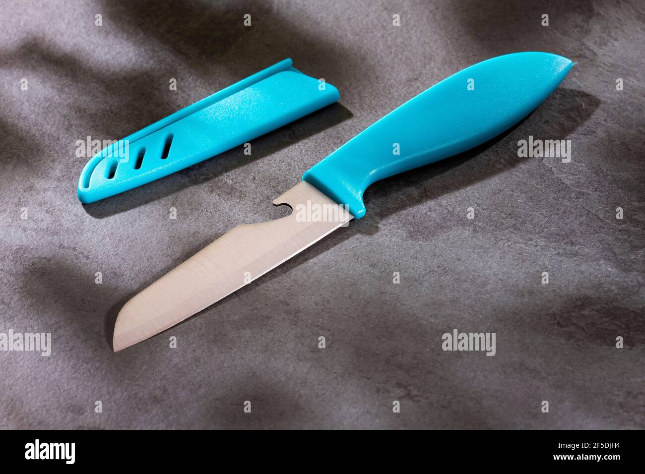 Kitchen knife with blue plastic handle with protector Stock Photo - Alamy