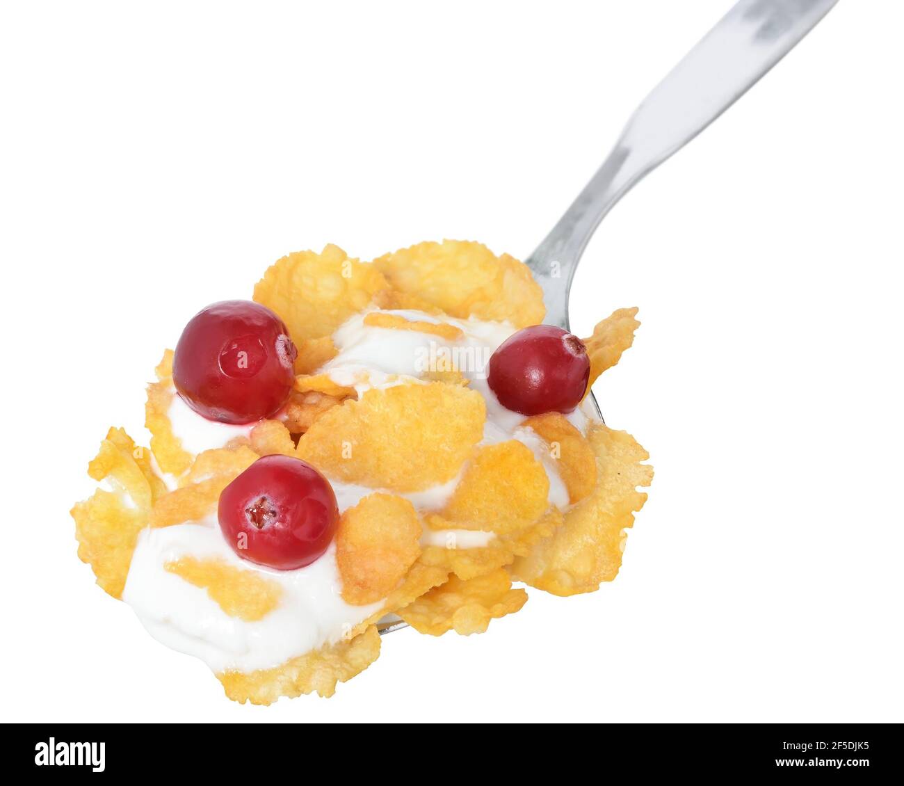 corn flakes in a spoon with yogurt on a white background Stock Photo ...
