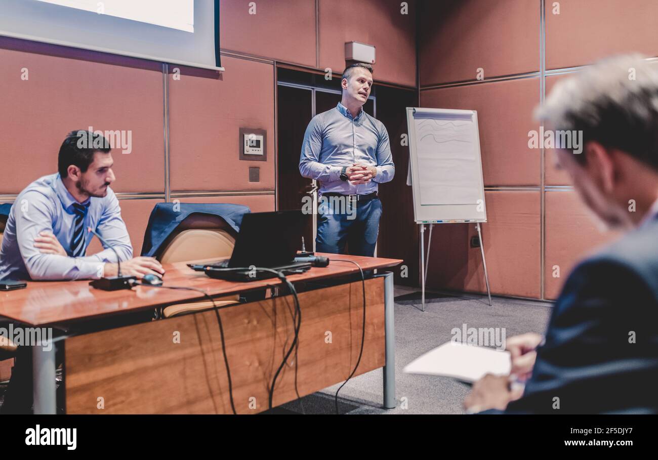 Business speaker giving a talk at business conference meeting event ...