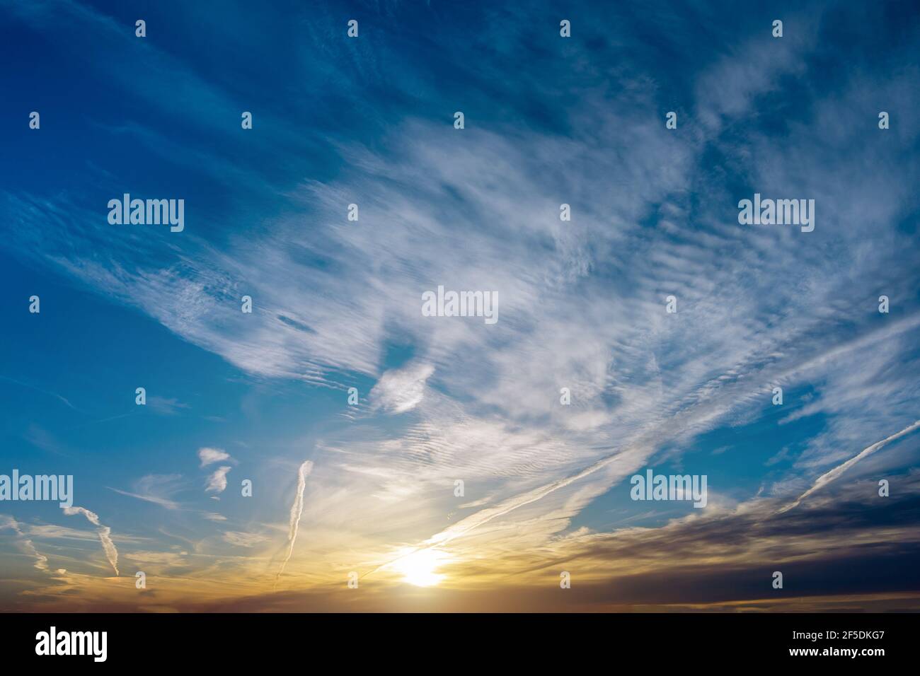 Beautiful sunset above clouds with dramatic light with blue sky, red ...