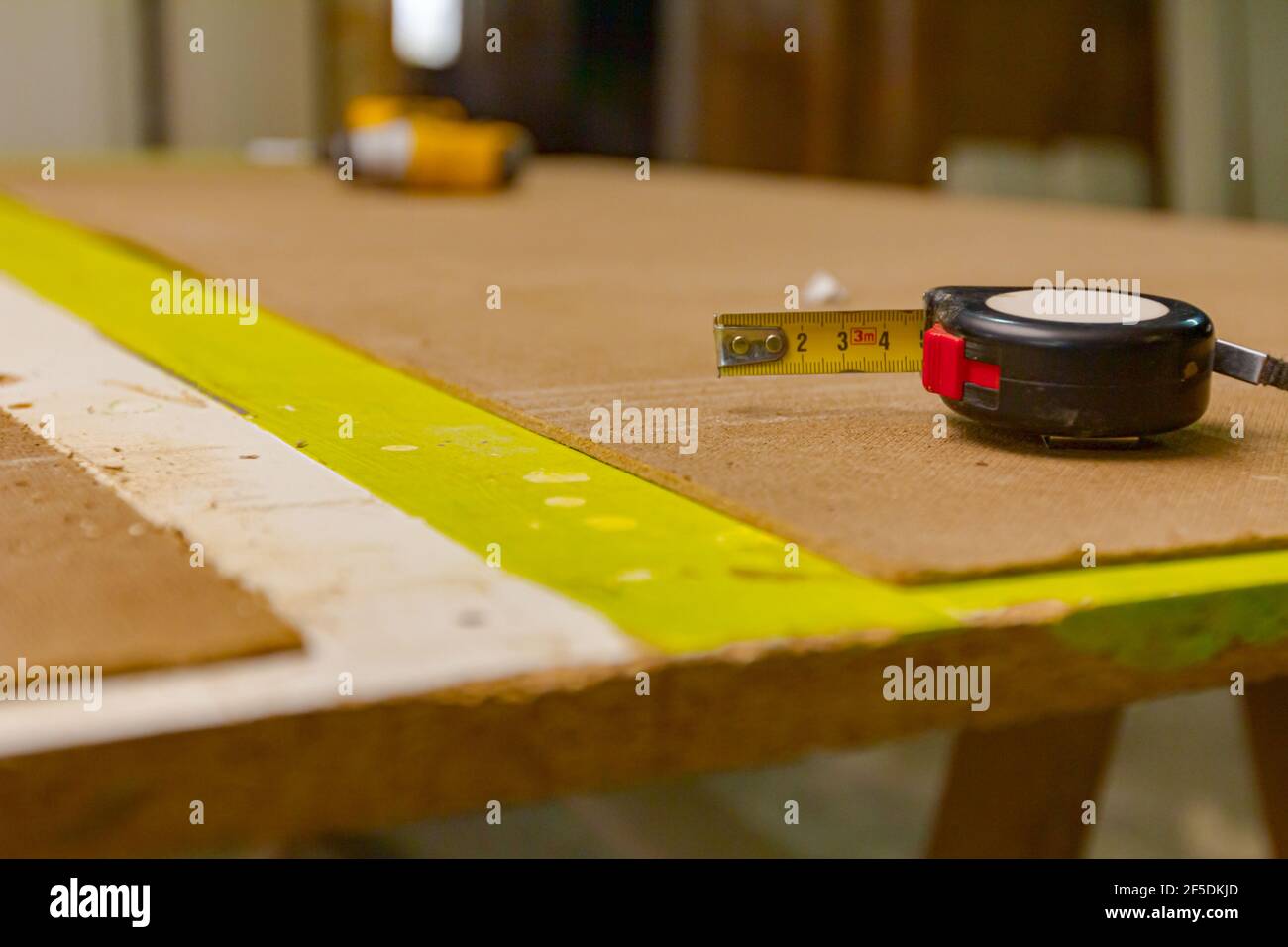 Measuring tape for measurement is placed on the plywood in carpentry ...