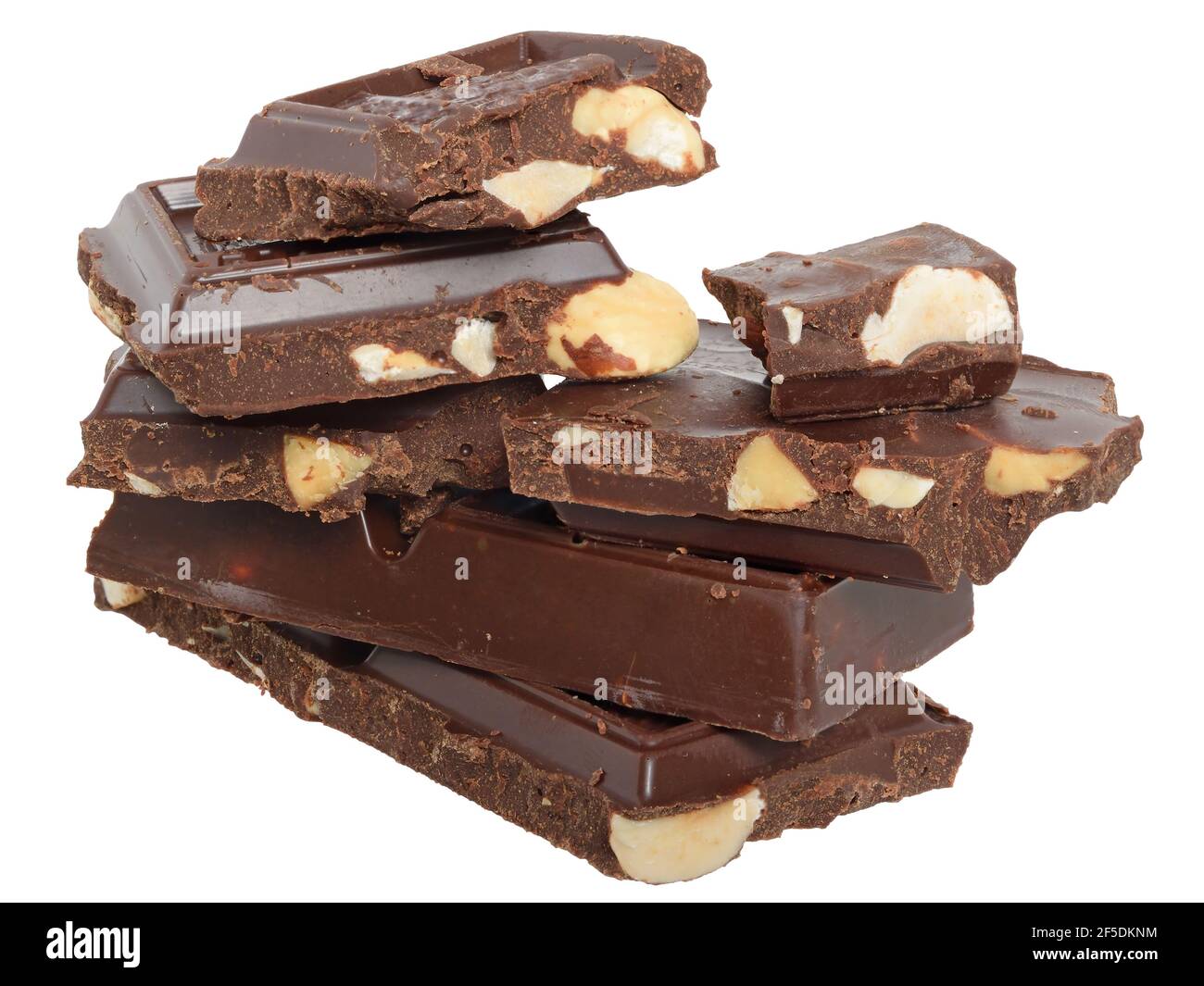 Heap cubes of chocolate with nuts close up isolated on white background ...
