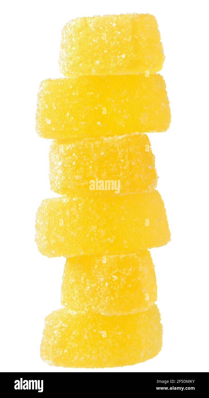 Tower of yellow candy on a white background Stock Photo - Alamy