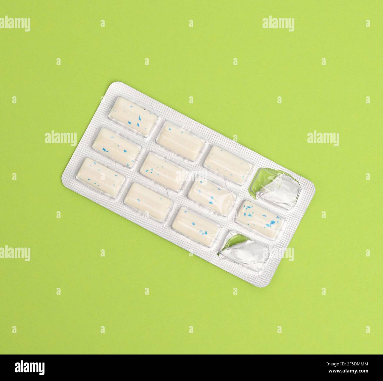 rectangular pieces of gum in a blister pack on a green background ...
