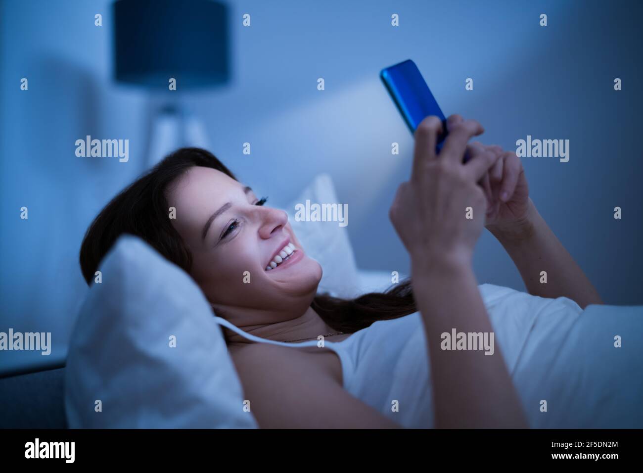 Insomnia Home Alone Using Phone Late At Night Stock Photo - Alamy
