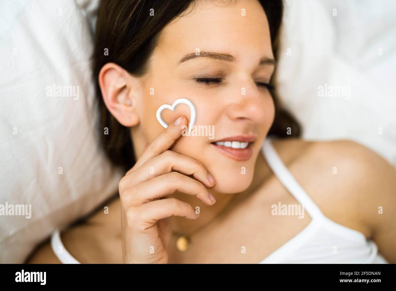 Beautiful Female Applying Face Creme Or Skin Lotion Stock Photo - Alamy