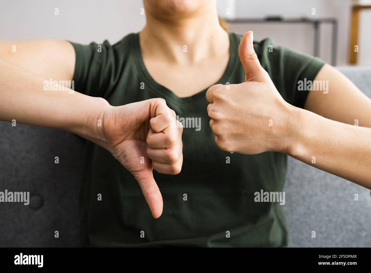 Confused Undecided Woman Showing Thumbs Up Down Gesture Stock Photo - Alamy