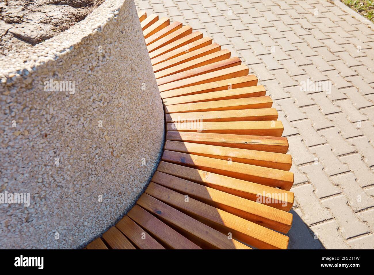 View of a round bench with a wooden seat Stock Photo - Alamy