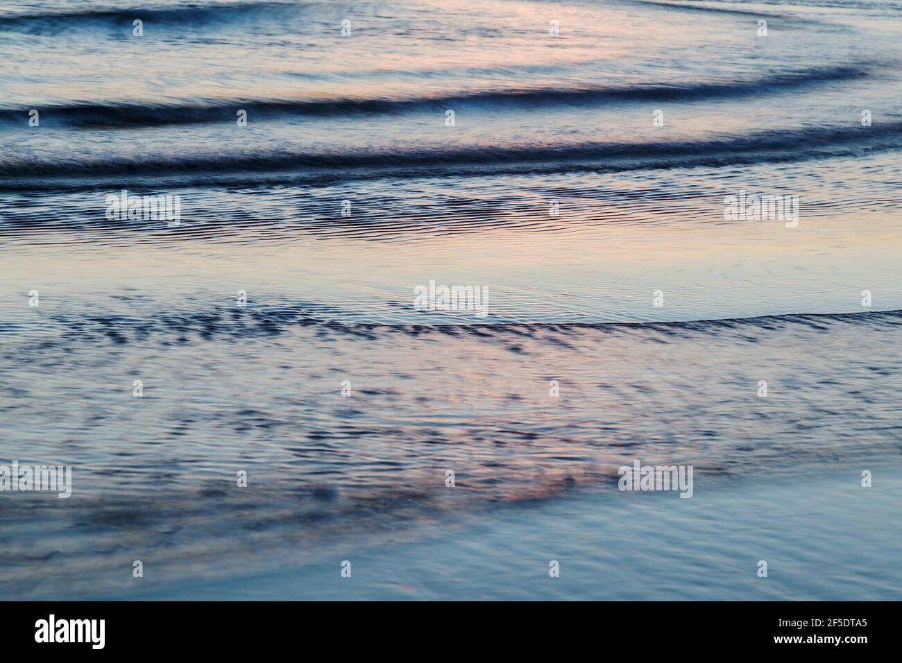 Vivid lights of the sea sunset with long exposure effect Stock Photo ...