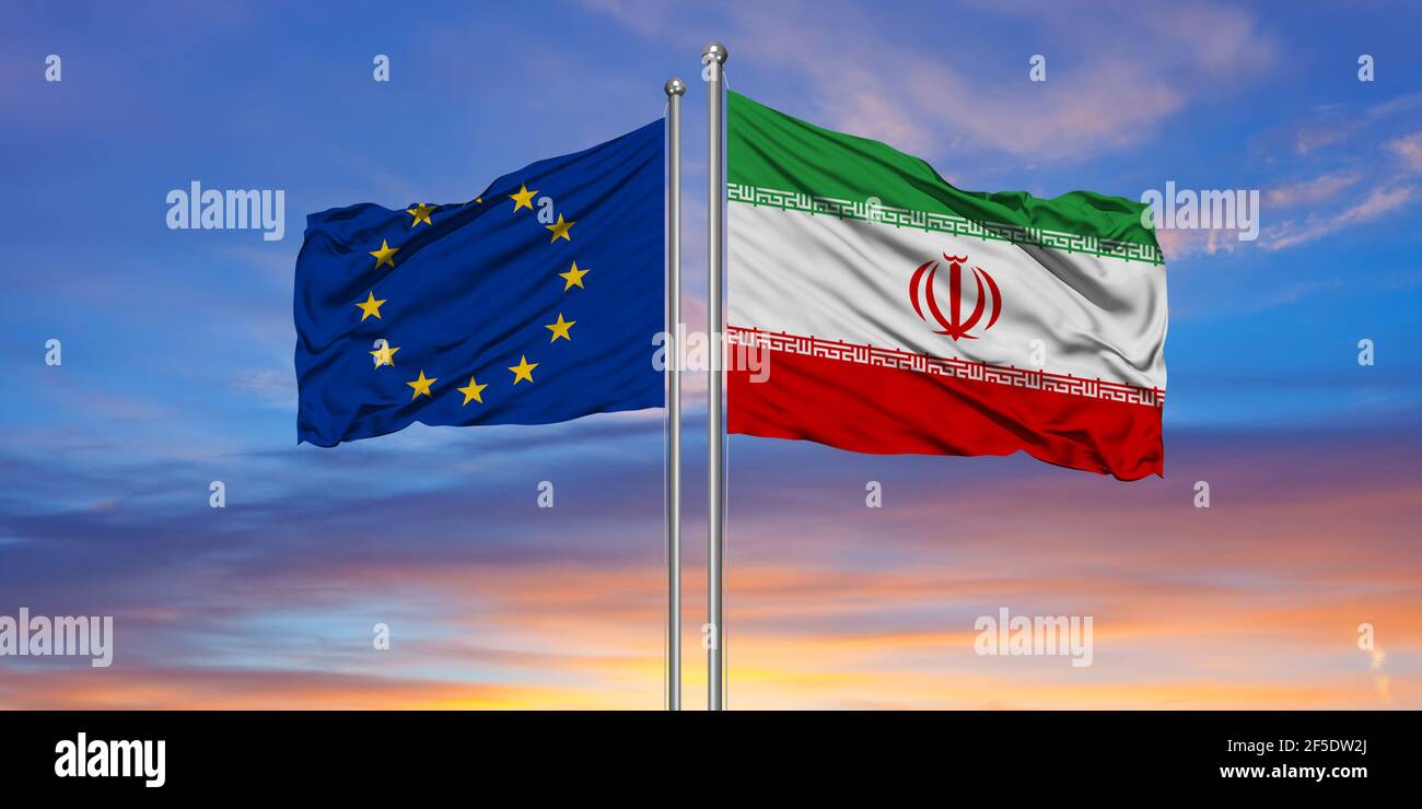 Flying flags of the european union and iran on high flagpoles Stock ...
