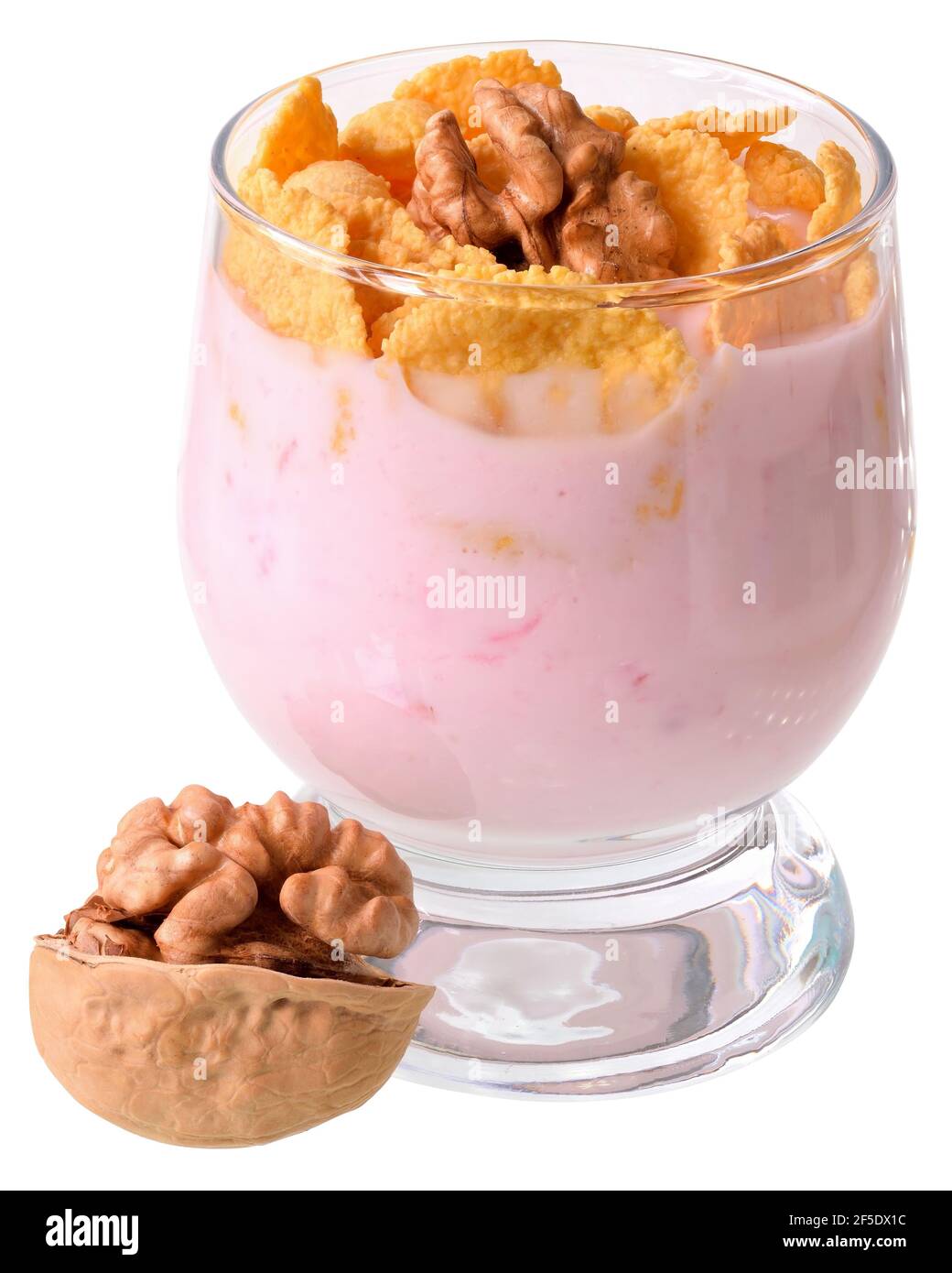 Yogurt with cornflakes and walnuts in a glass goblet isolated on a ...