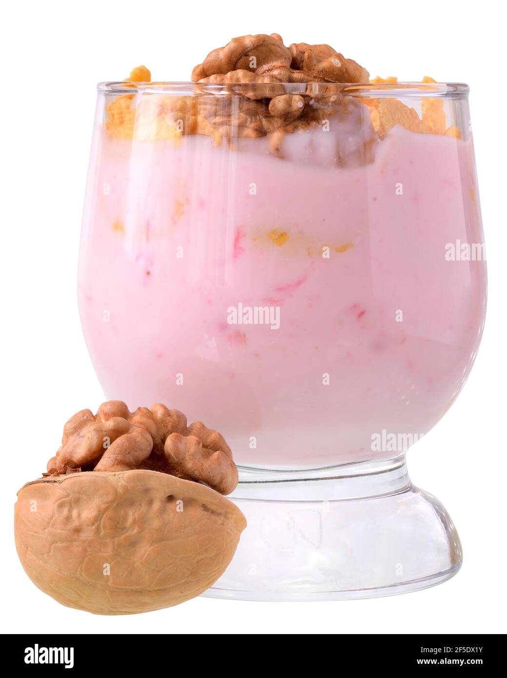 Yogurt with cornflakes and walnuts in a glass goblet isolated on a ...