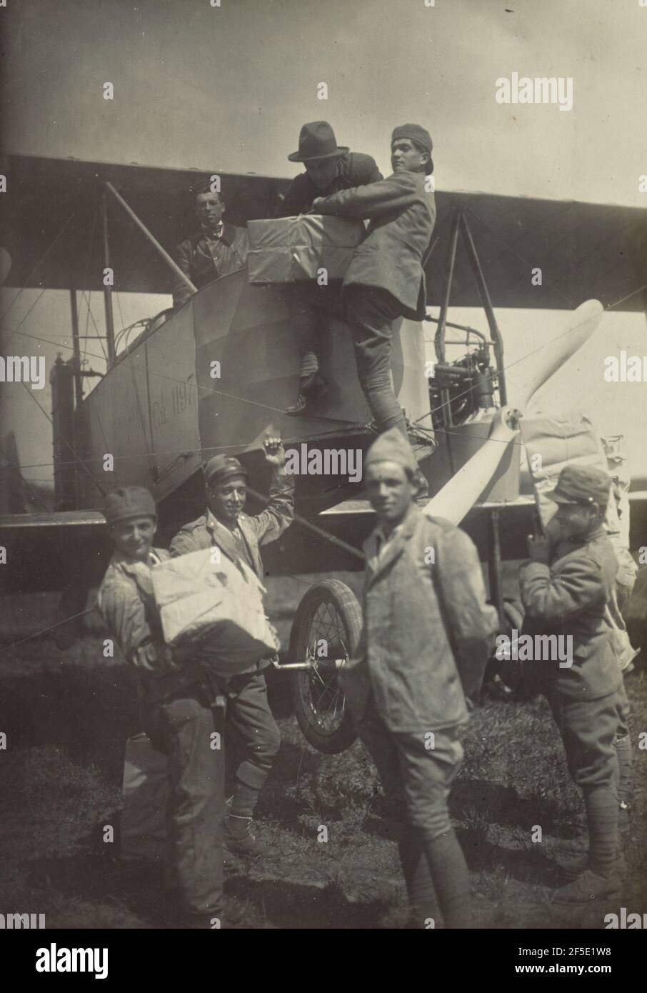 Group congregating around an airplane. Fédèle Azari (Italian, 1895 ...