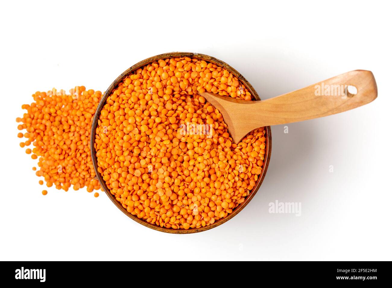 Raw seeds of orange lentils in wooden bowl, spoon isolated on white background Top view Flat lay ...