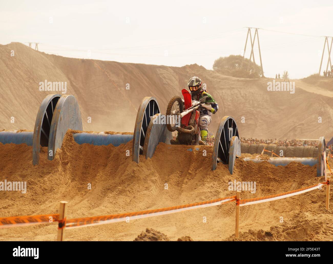 Motorbike enduro races. The competitor overcomes the obstacle along the ...