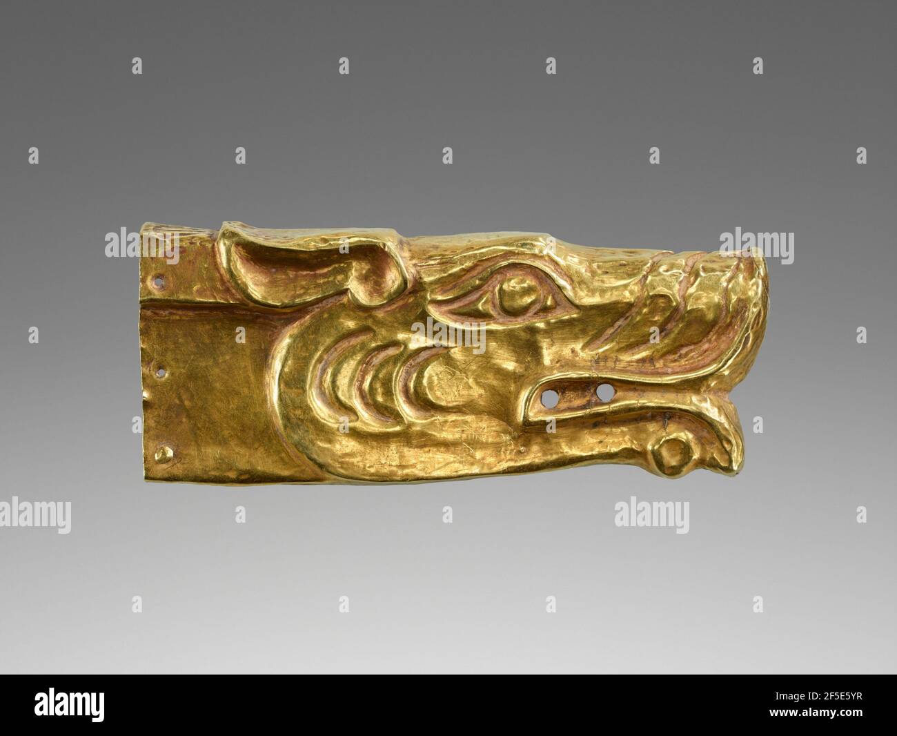Applique in the shape of a wolf head worked in repousse. Unknown Stock ...