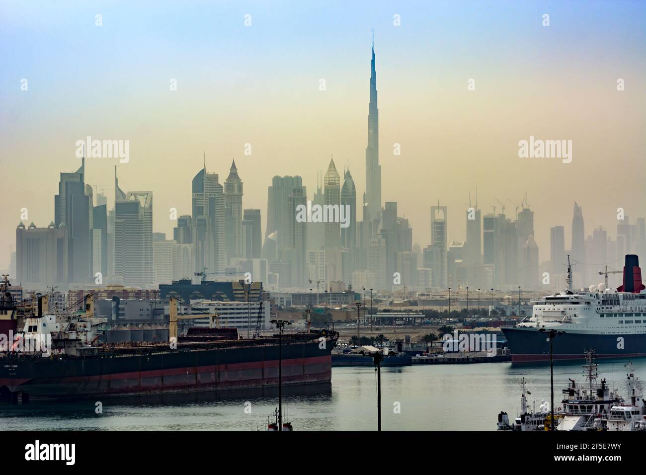 Landscape of the Dubai skyline surrounded by ships and sea in the ...