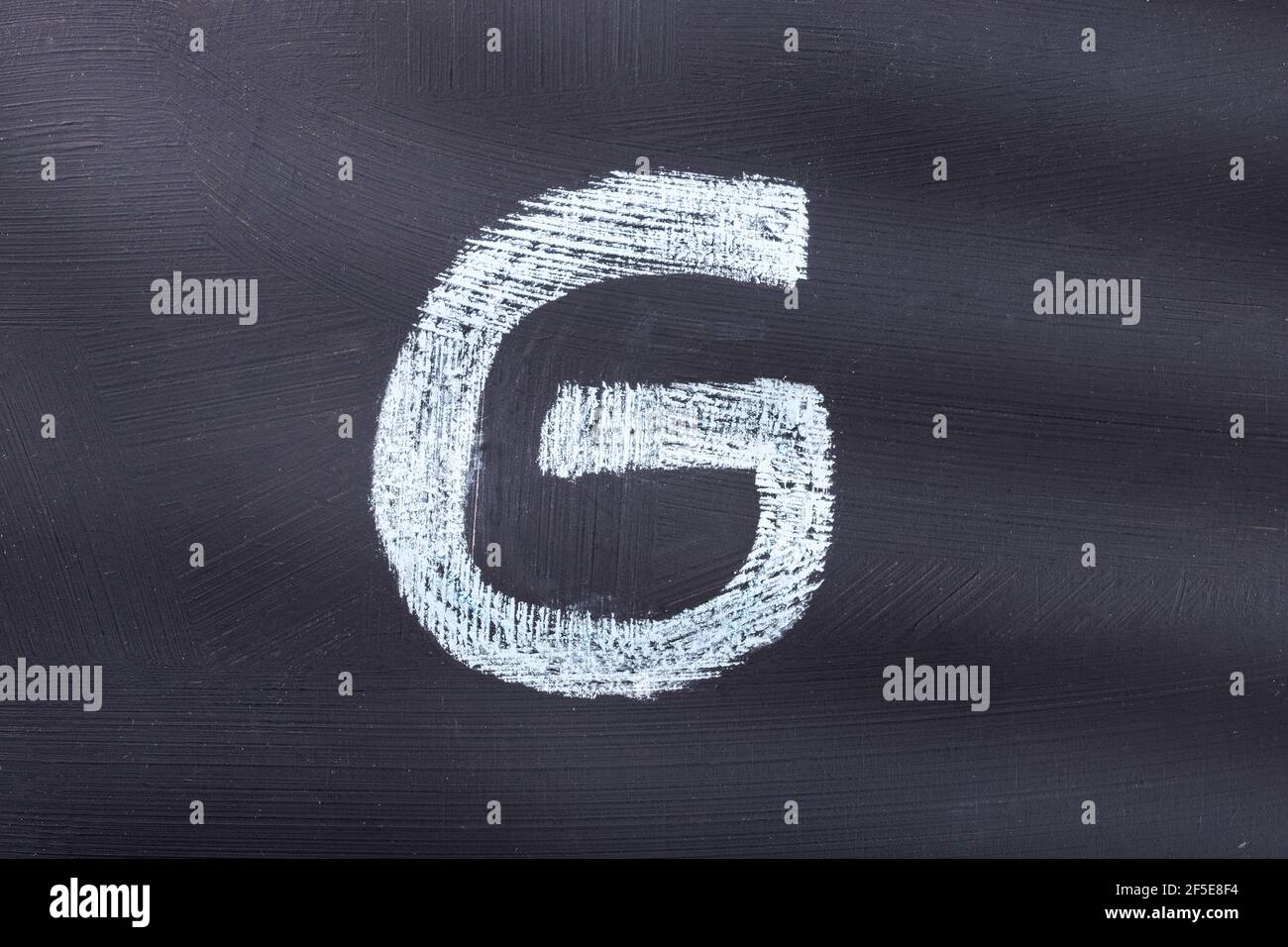 Letter G of the alphabet written with chalk Stock Photo - Alamy
