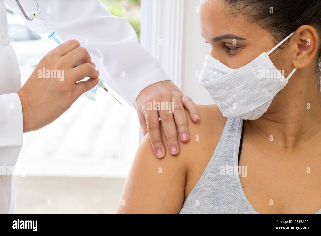 Medical mask patient looking applying injection. Close up Stock Photo ...