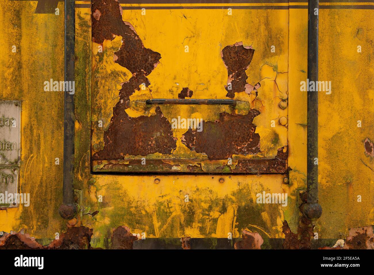 Rusted yellow iron surface of a old train in a beautiful rough ...