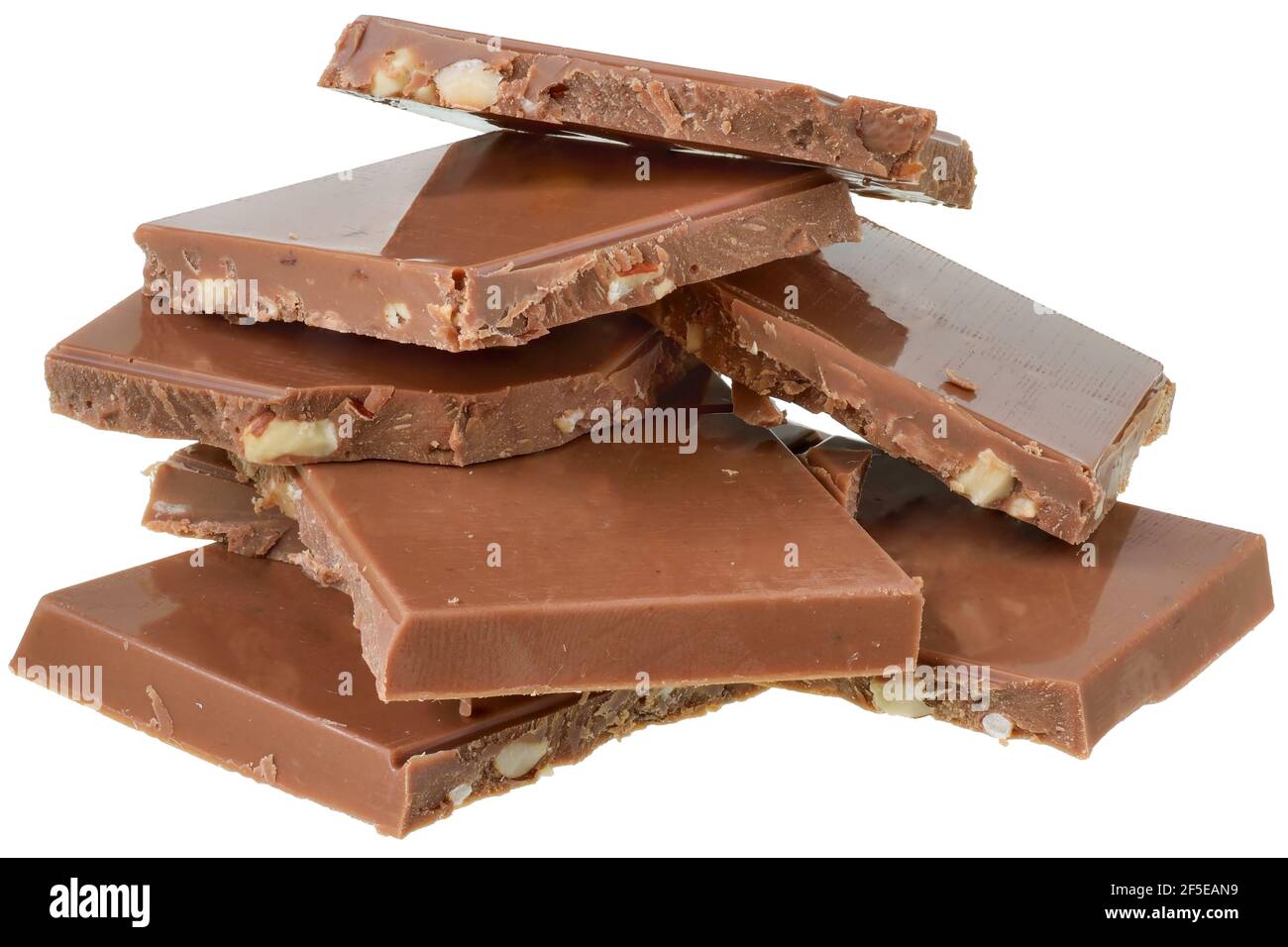 Heap cubes of chocolate with nuts close up isolated on white background ...