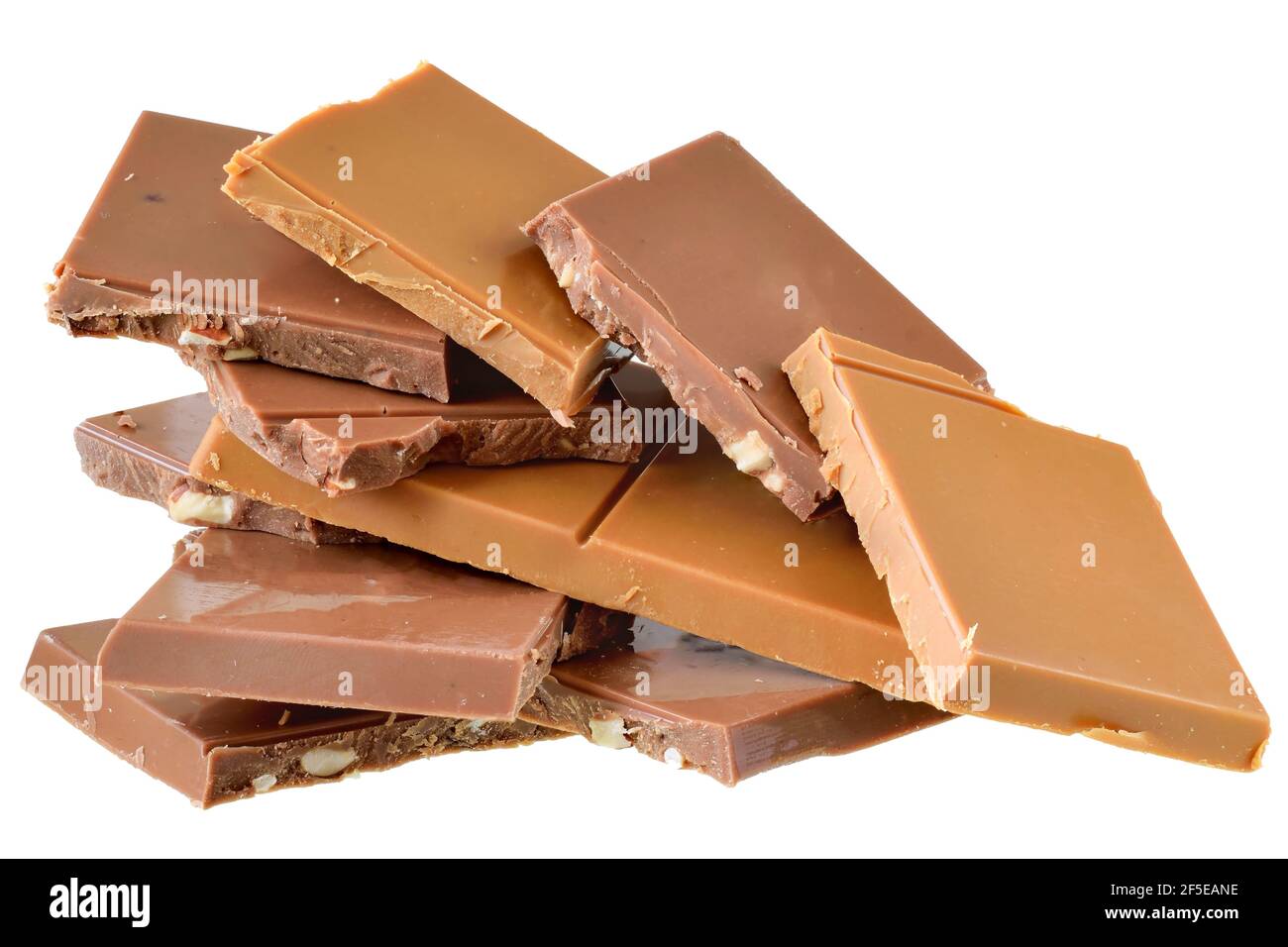 Heap cubes of chocolate with nuts close up isolated on white background ...