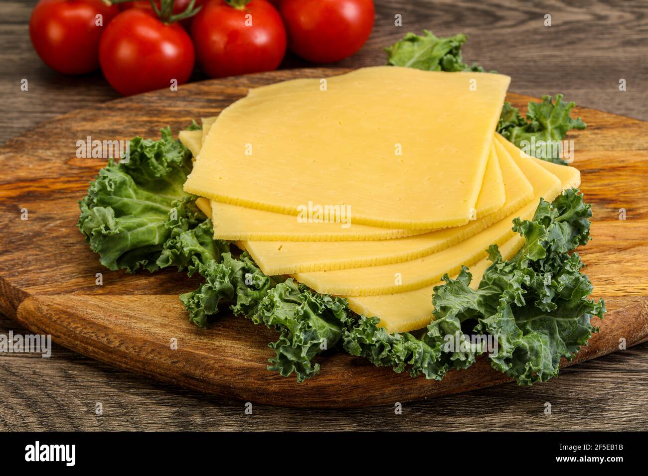 Sliced Gauda cheese snack over board Stock Photo - Alamy