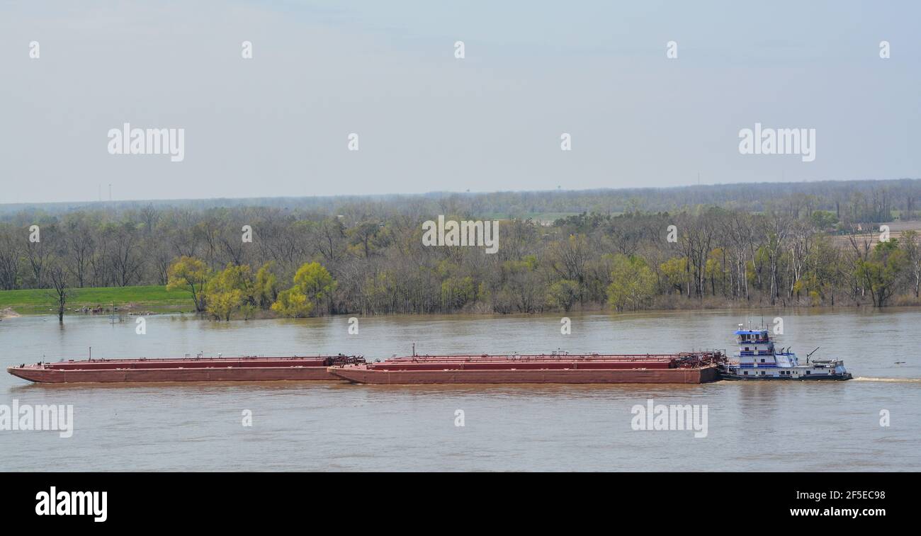 A Tug Boat is pushing Barges down the Mississippi River past Natchez ...