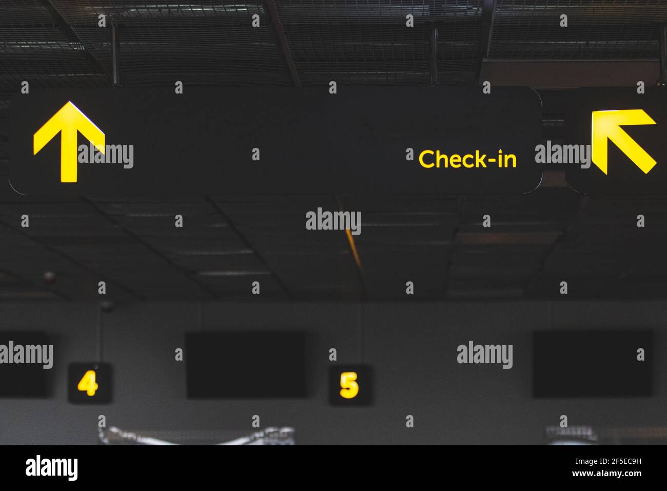 Airport informaction signs. Arrow on information screen to check-in ...