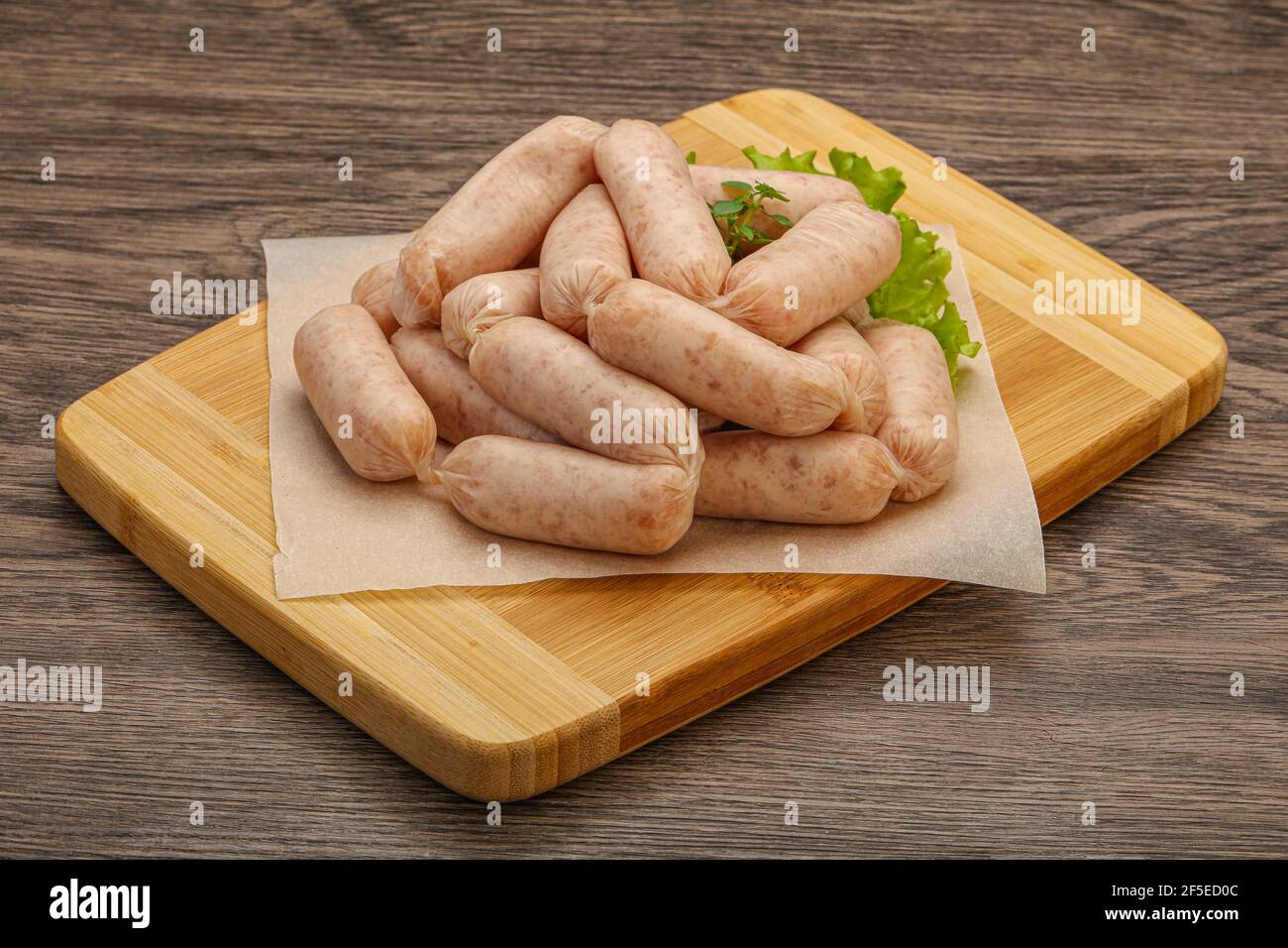 Raw natural chicken baby sausages for roast Stock Photo - Alamy