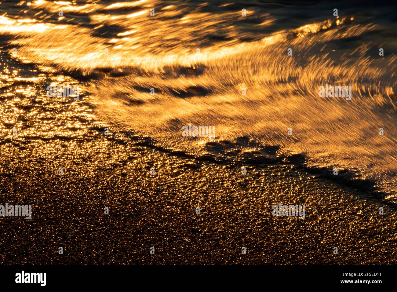 Vivid lights of the sea sunset with long exposure effect Stock Photo ...