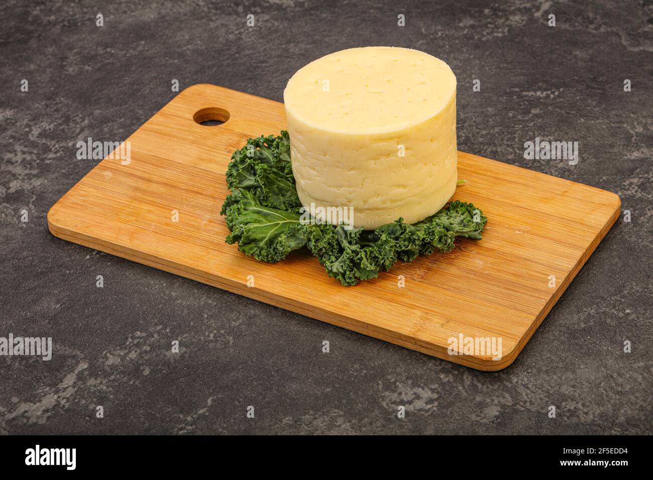 Yellow round dairy soft cheese piece Stock Photo - Alamy