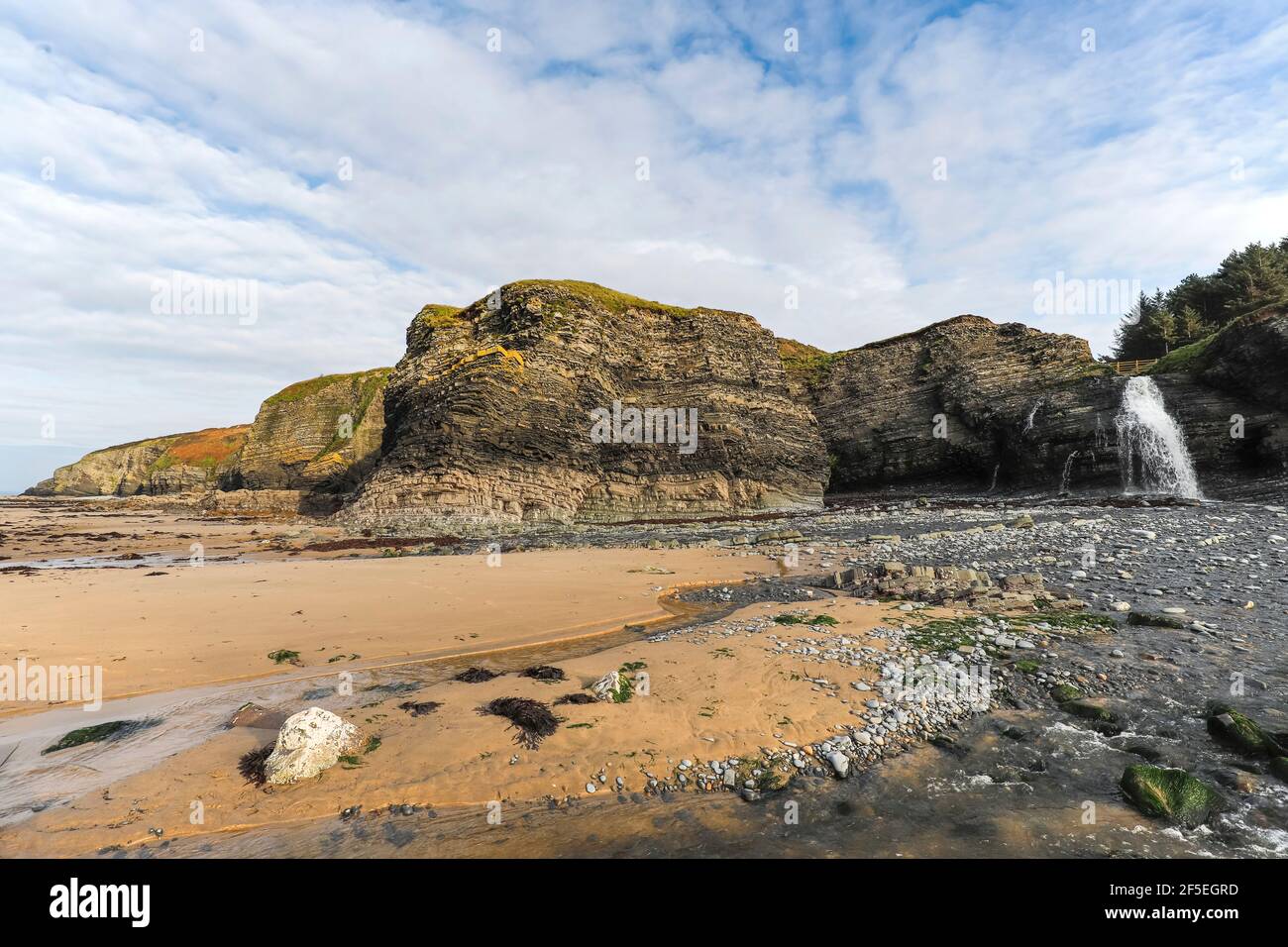 Beach waterfall where the Afon Drywi tumbles over cliffs of Silurian ...