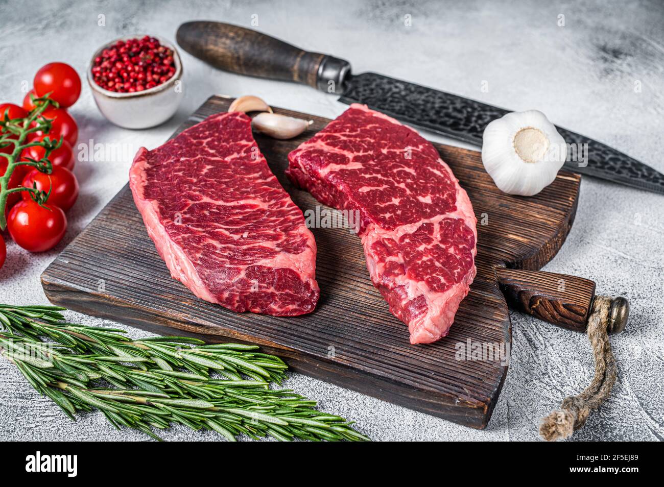 Raw denver cut black angus organic steak on a butcher cutting board ...