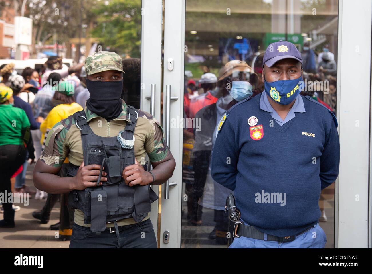 Johannesburg, South Africa. 26th Mar, 2021. Police and security stand ...