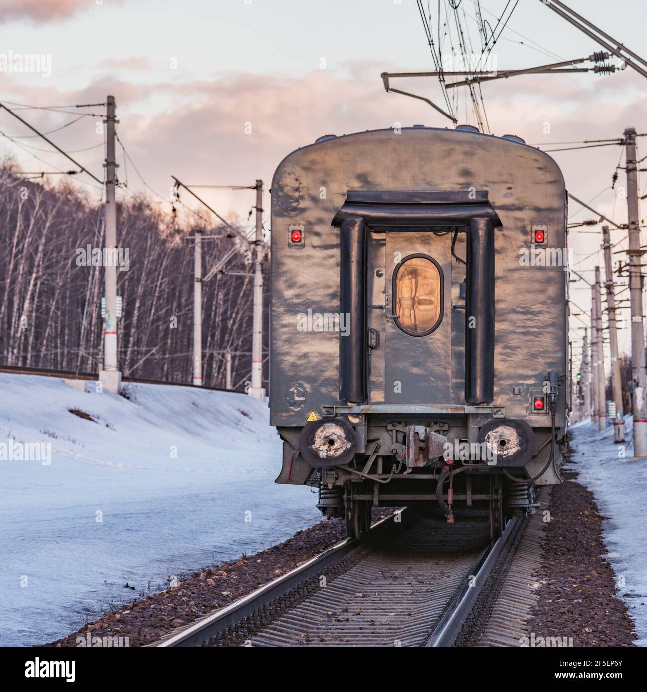 Last carriage of the passenger train approaching to the station Stock ...