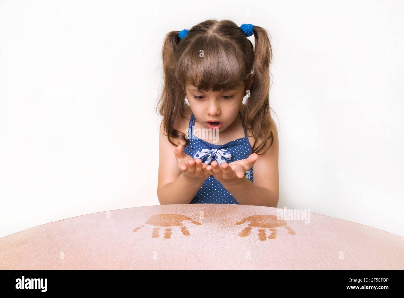 Allergy to dust in a child. Girl looks at hands in dust Stock Photo - Alamy