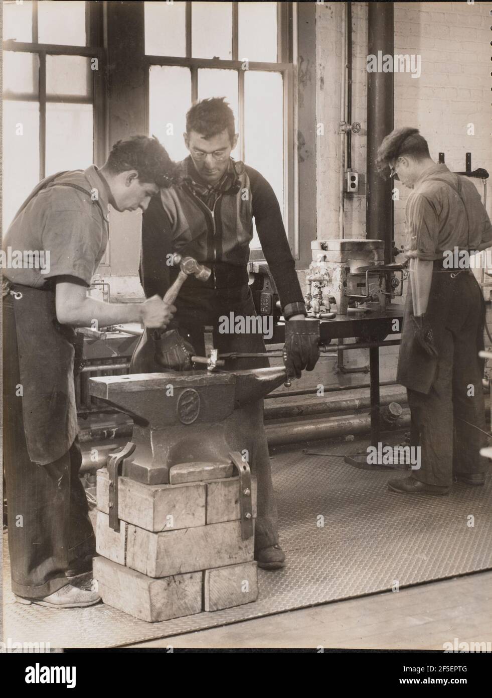 Two men hammer metal on an anvil. Arnold Eagle (American, 1909 - 1992 ...