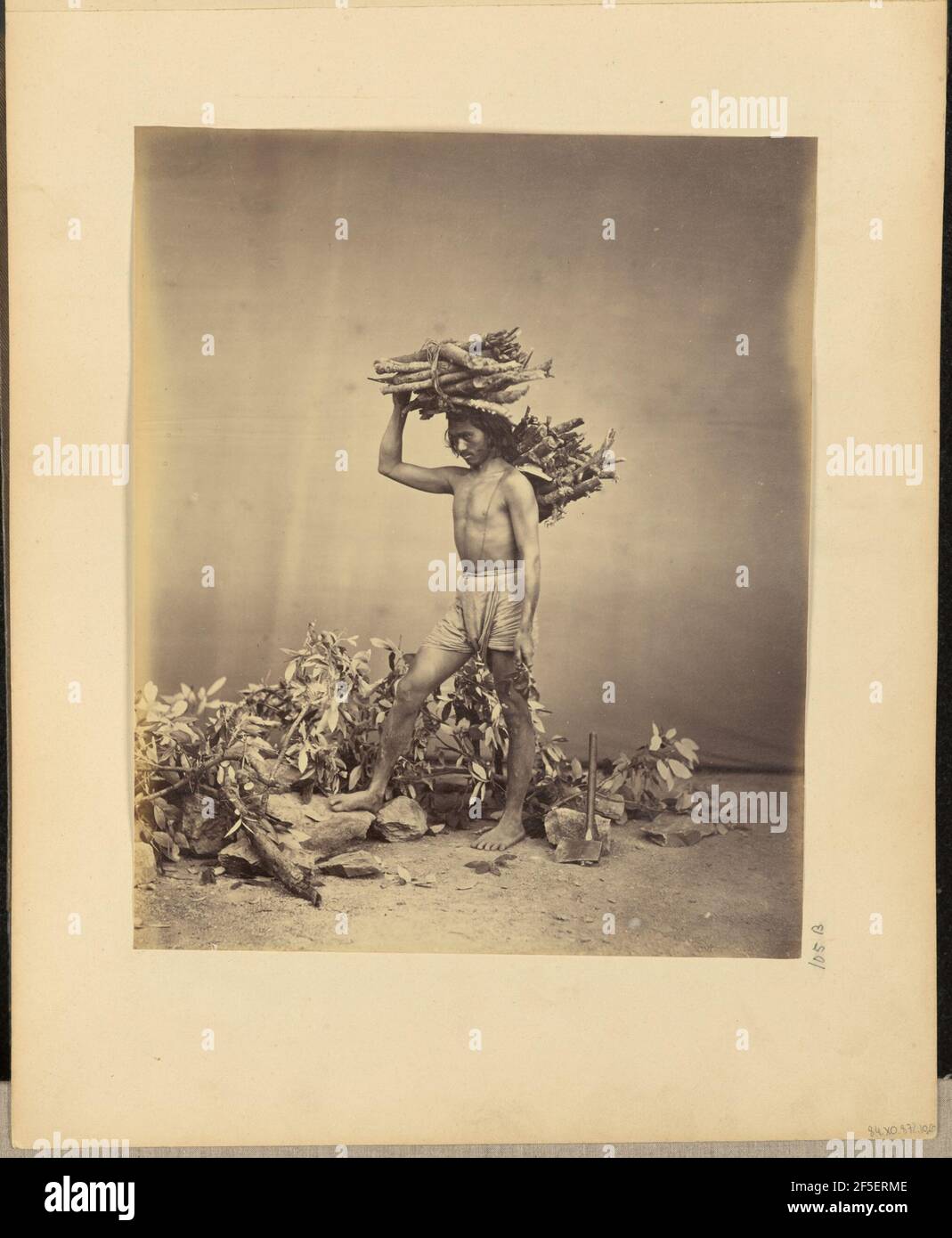 Indian peasant man holding twigs on his head. John Edward Saché ...