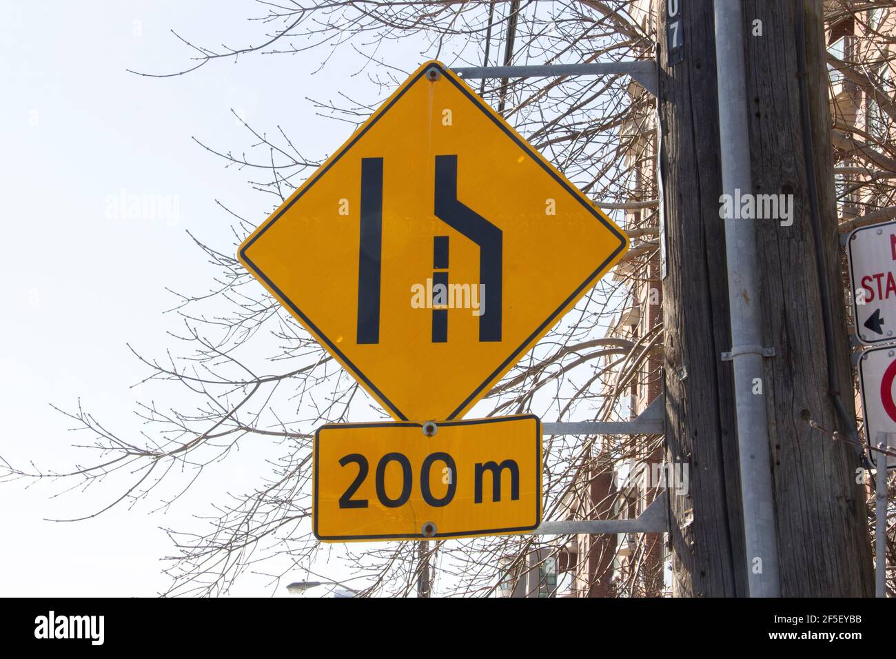 Merging lane traffic sign Stock Photo - Alamy