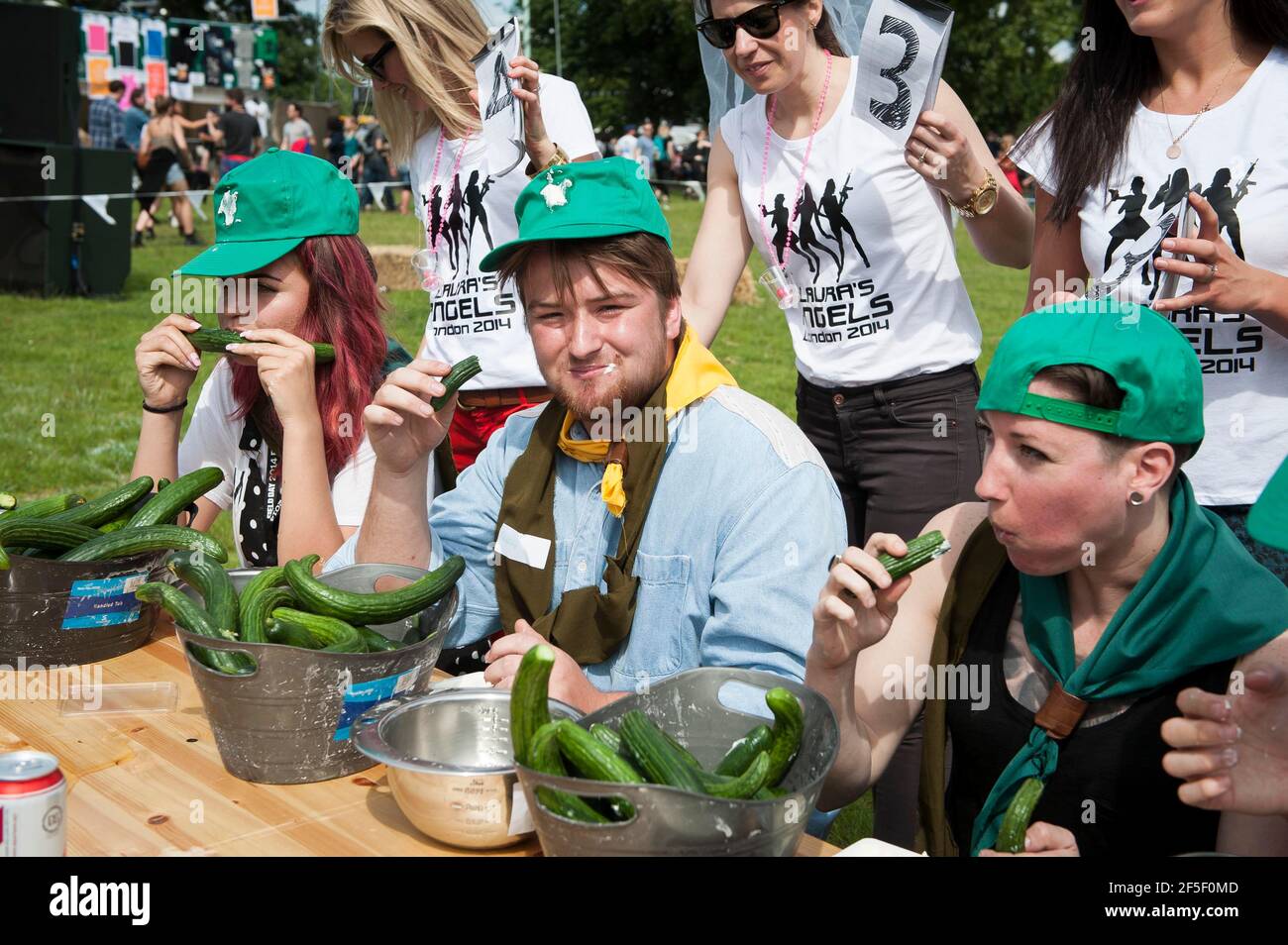 Festival goers compete in a cucumber eating competition on day one of ...