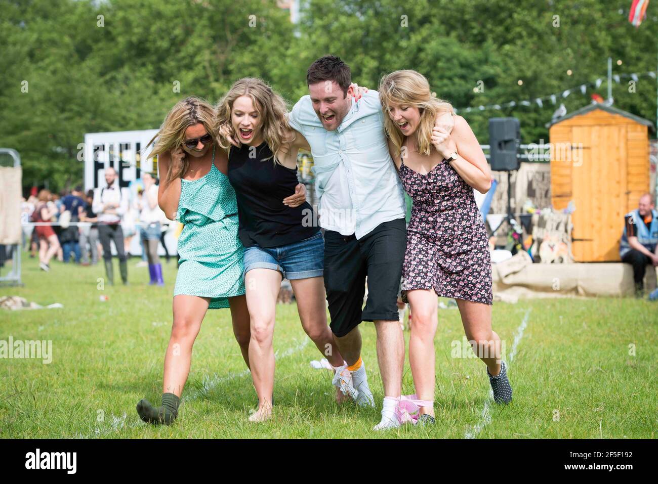 Festival goers competeing in the 5 legged race on day one of Field Day ...
