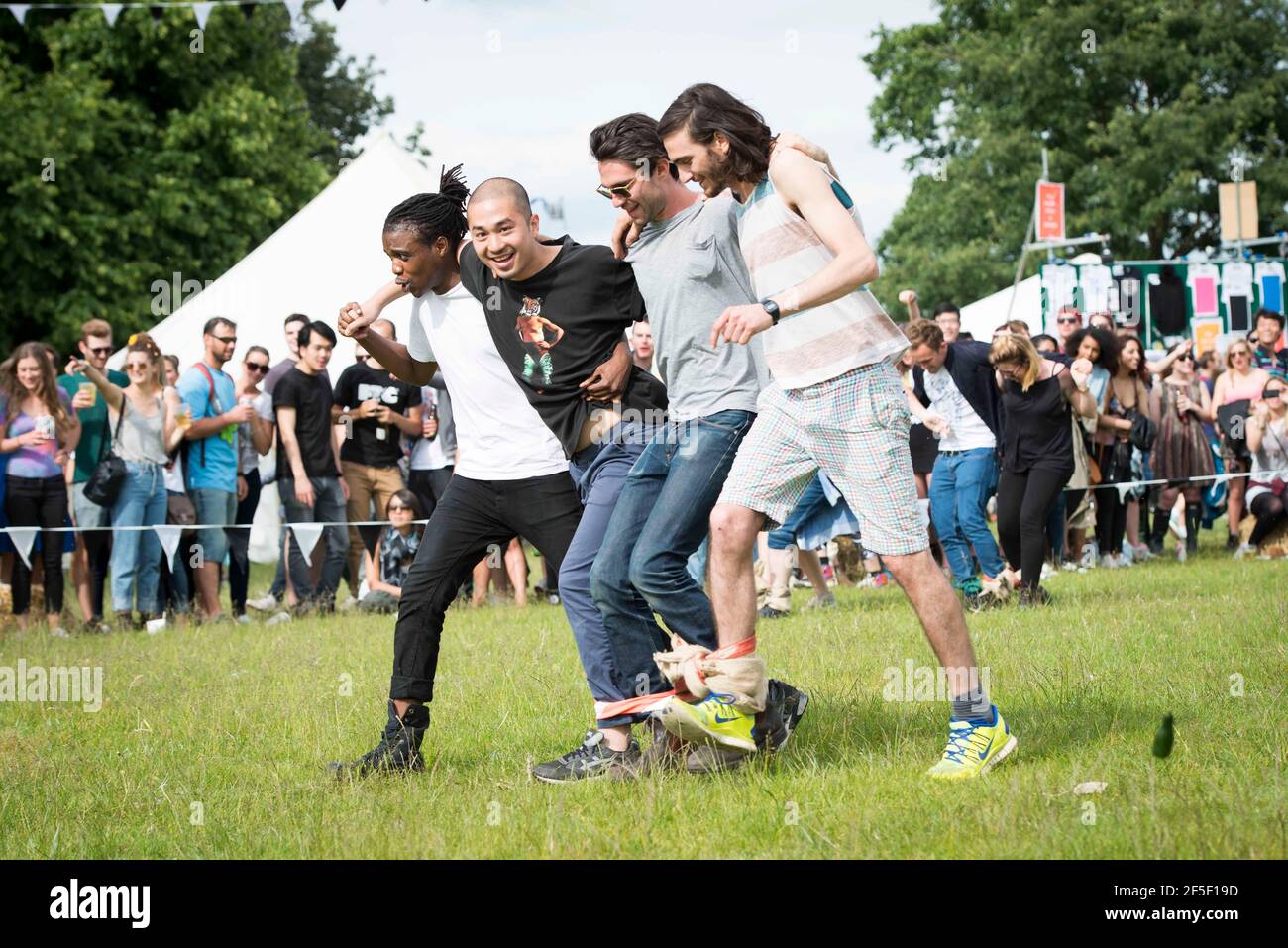 Festival goers competeing in the 5 legged race on day one of Field Day ...